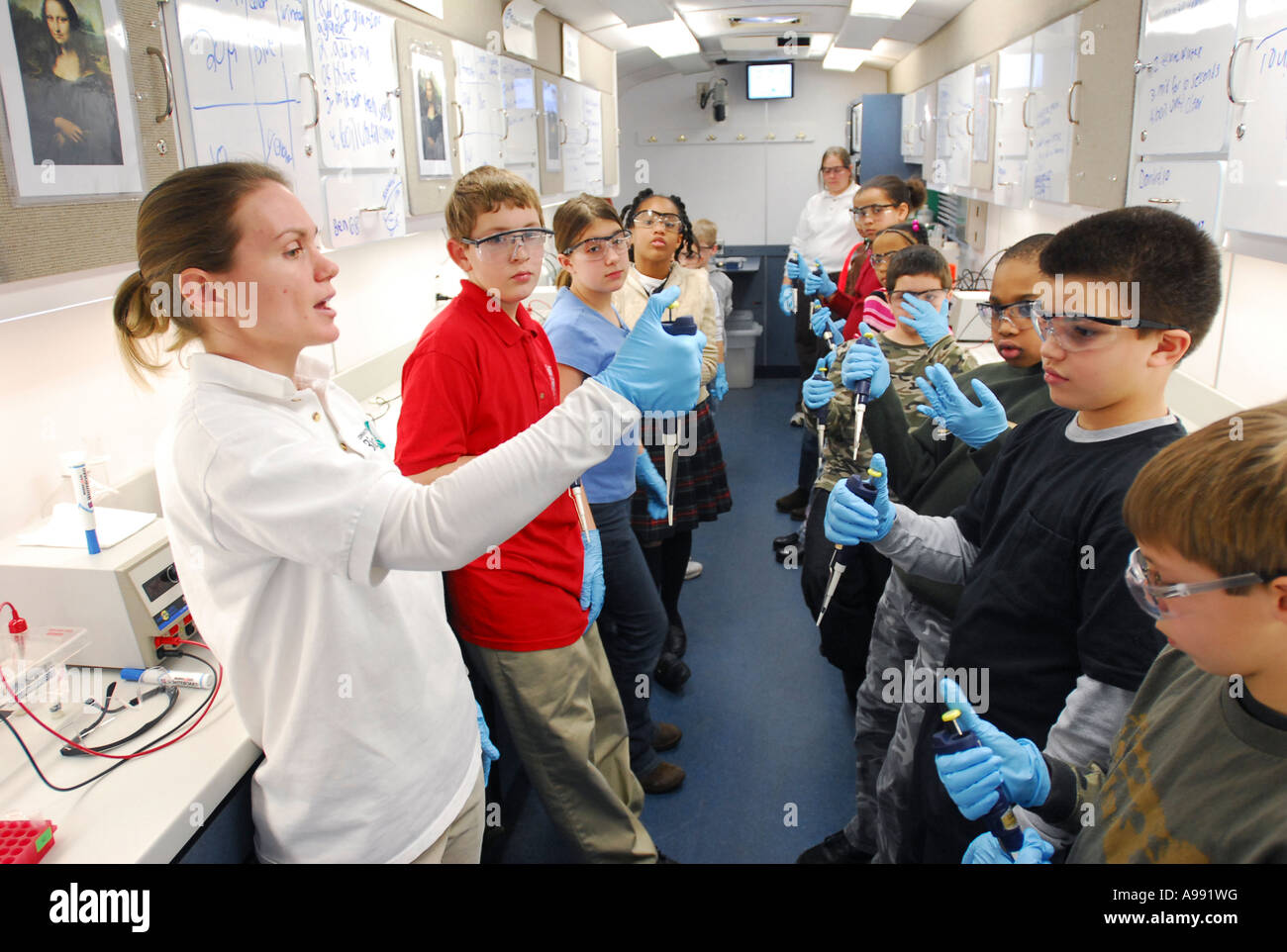 A teacher works with Students as they learn to sequence DNA during a ...