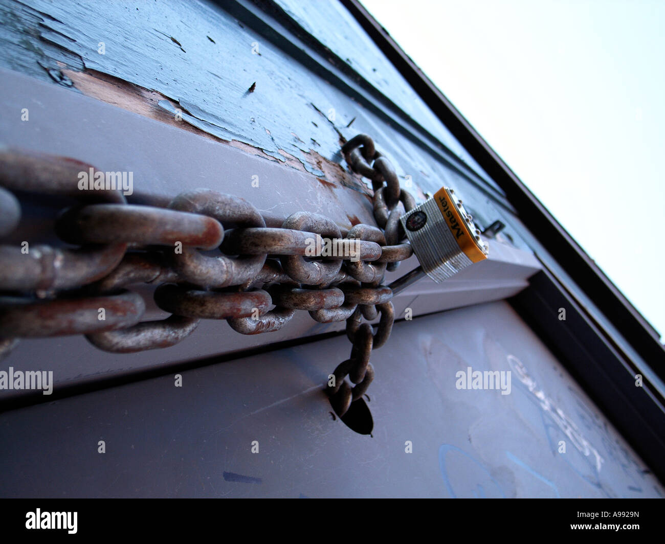 Lock and chain on blighted urban building security and locked concepts ...