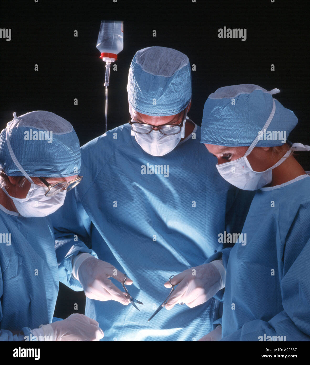surgeon and two assistants performing a medical operation Stock Photo ...