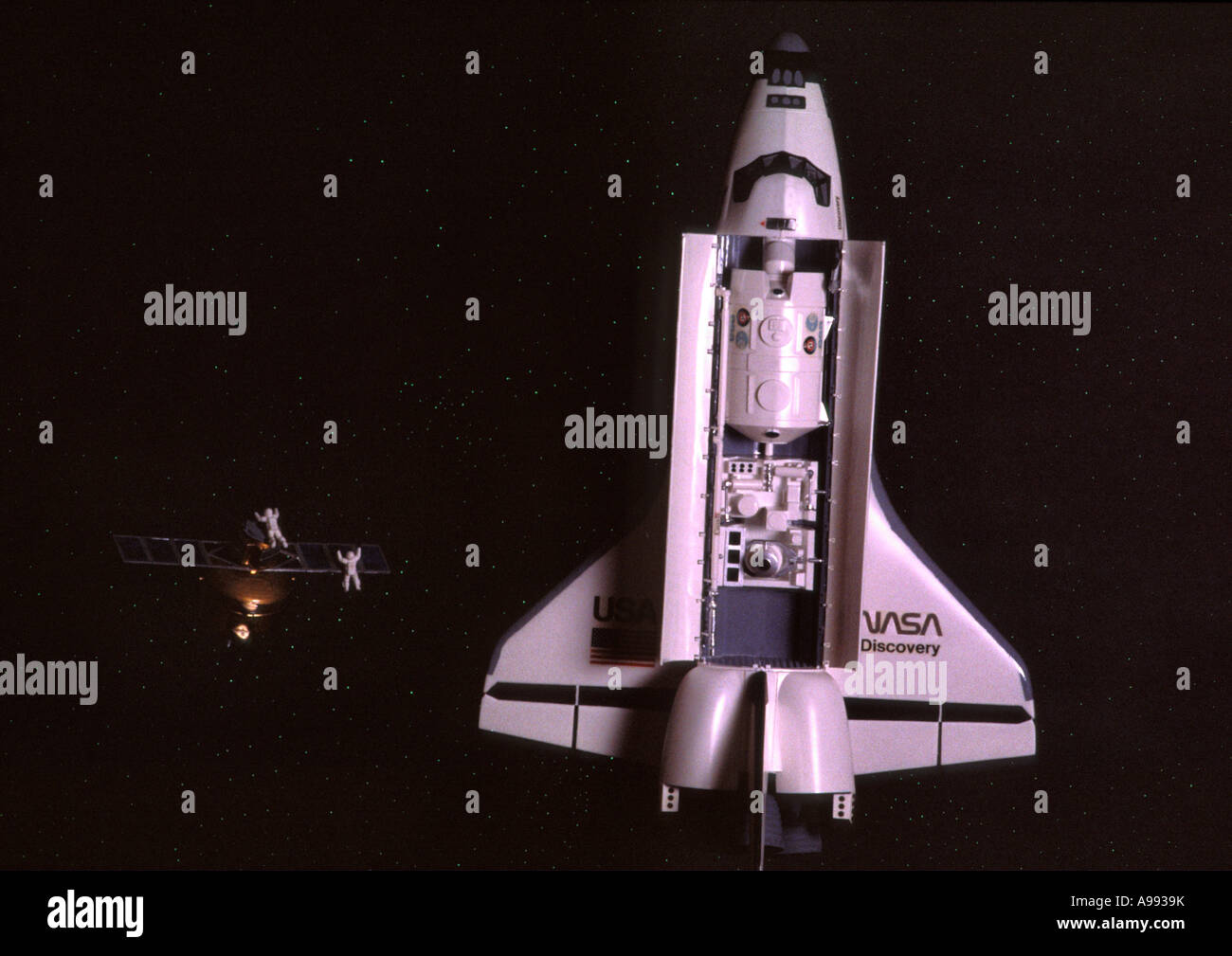 models of the space shuttle in space and a satellite being fixed by ...
