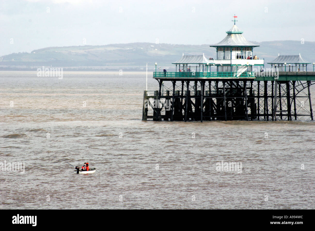 Man Fishing from a dinghy in the Bristol Channel, Clevedon, Somerset ...
