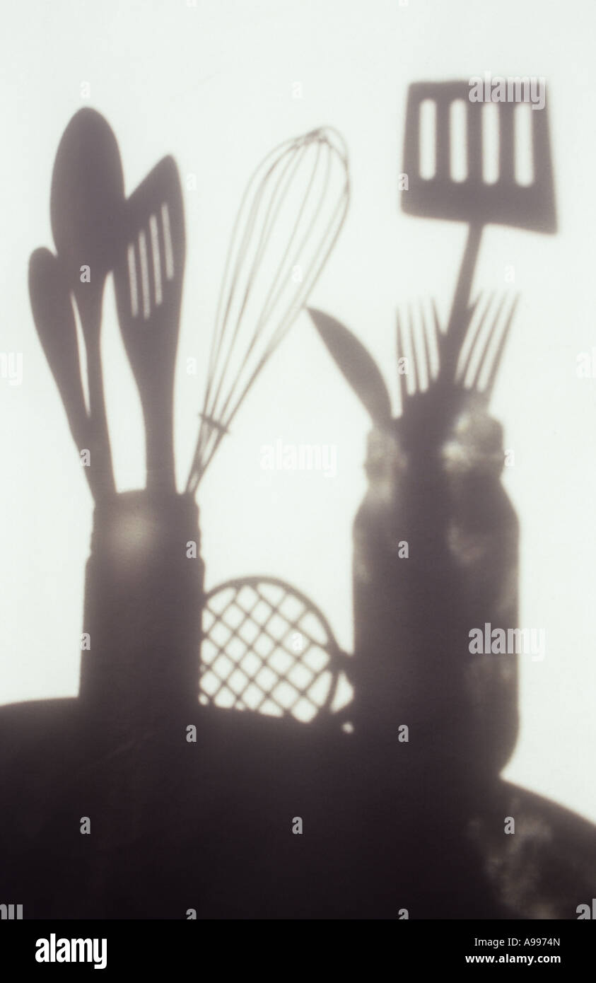 Shadow in warm light on pale cloth or curtain of kitchen utensils in ...