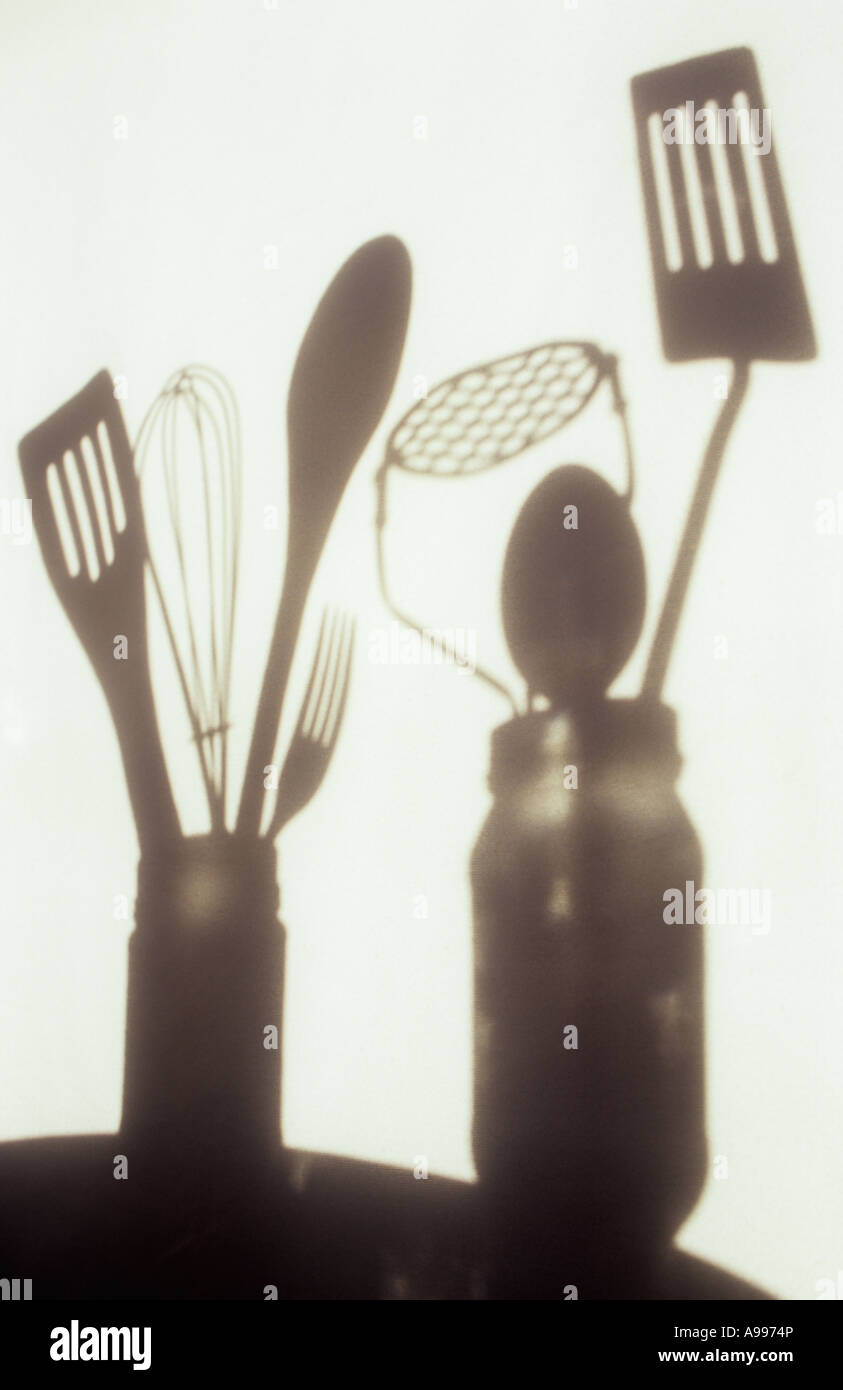 Shadow in warm light on pale cloth or curtain of kitchen utensils in ...