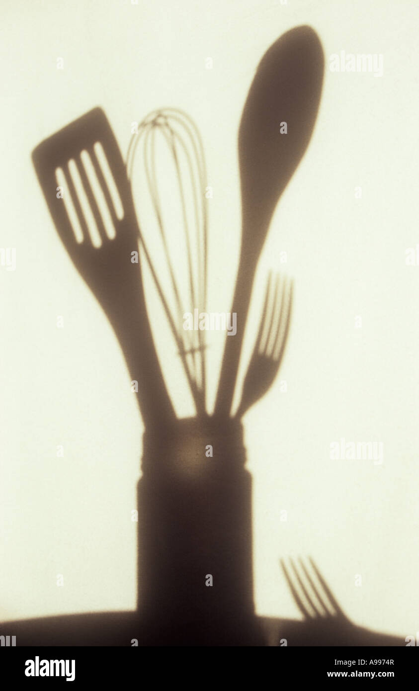 Shadow in warm light on pale cloth or curtain of kitchen utensils in ...