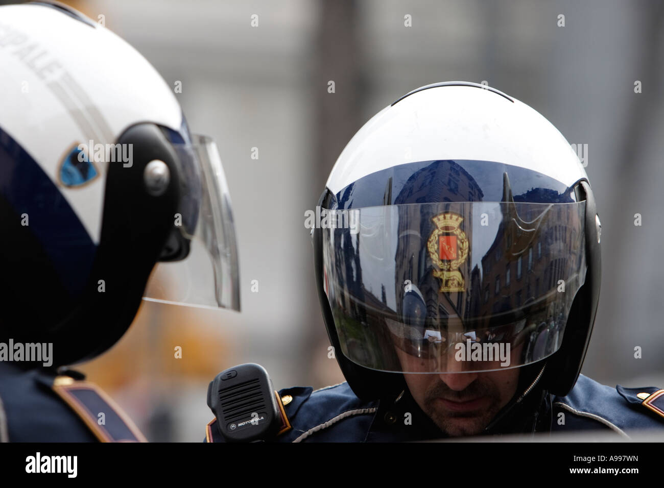 Police officer wearing crash helmet writes parking tickets in Rome ...
