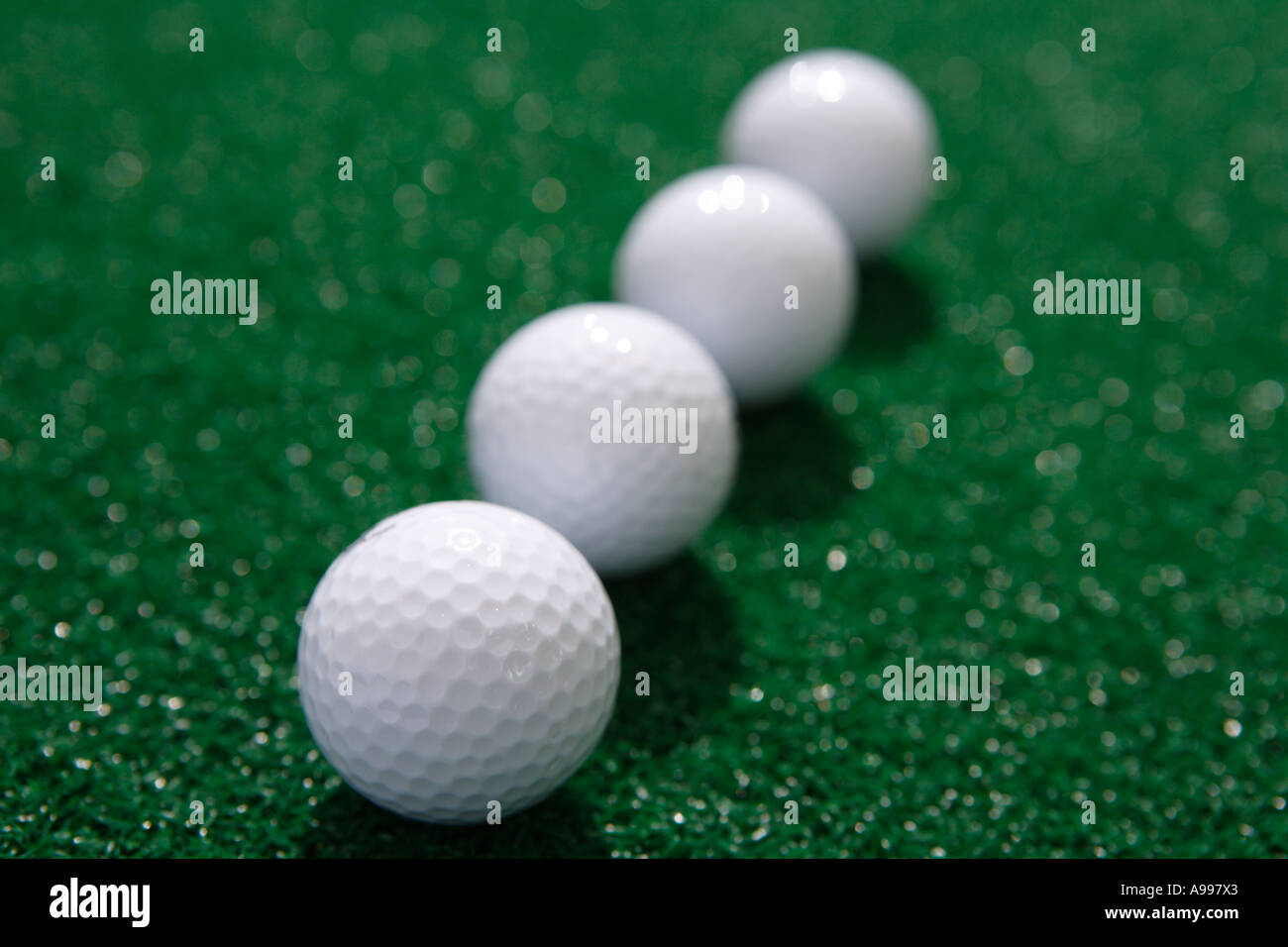 Golf Balls in a row on Astro Turf Stock Photo - Alamy