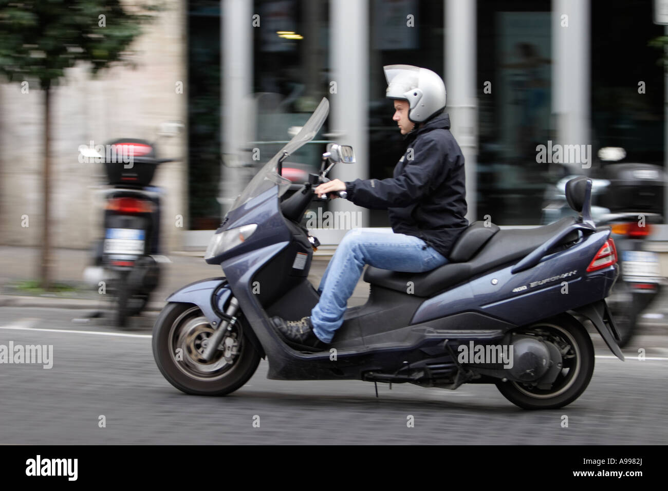 A man rides a scooter in downtown Rome, Italy Stock Photo - Alamy