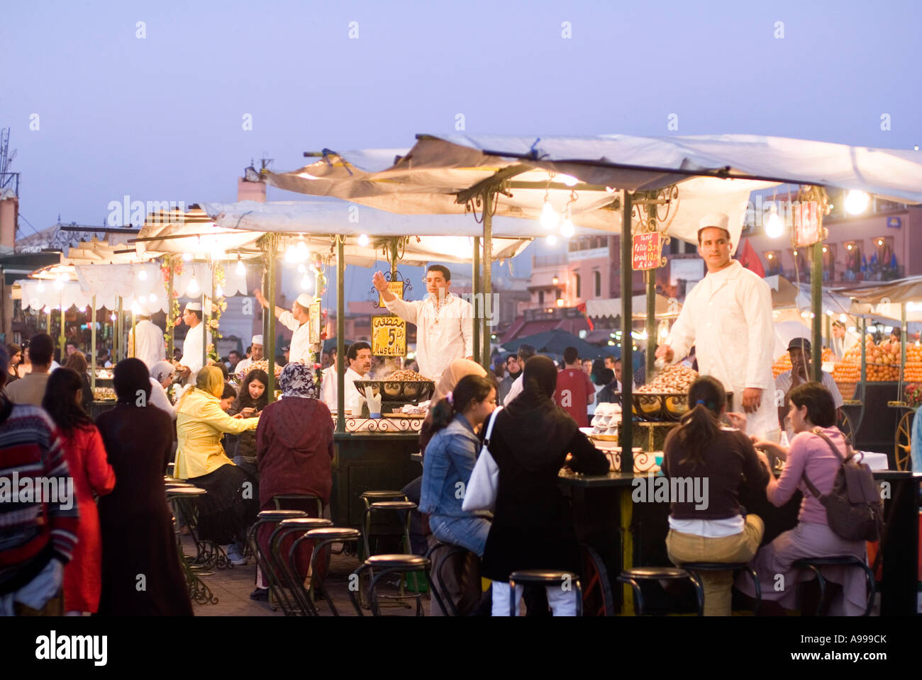 Busy open air food stalls selling escargot or snail soup on the central ...