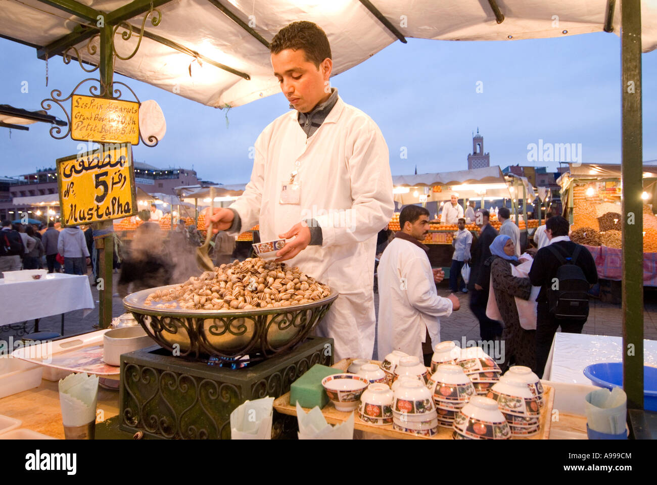 Open air food stall vendor serving escargot or snail soup on the ...