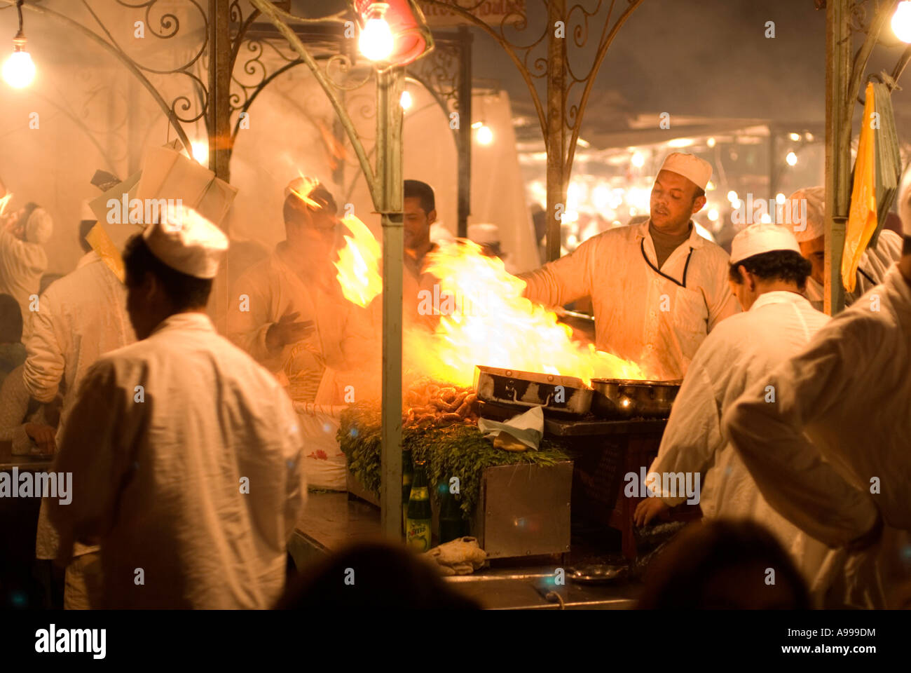 Open air food stall vendor grilling kebabs and sausages on the central ...