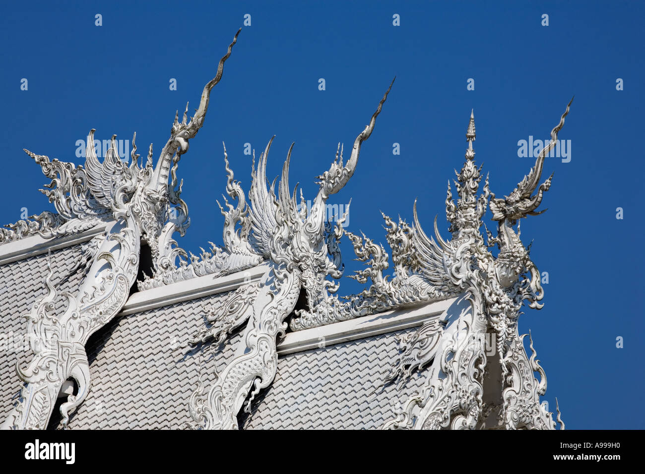 The ornate rooftop of the beautiful white temple of Wat Rong Khun in ...