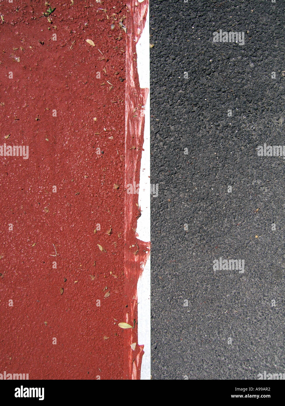 brown red paint on road - cycle path construction Stock Photo - Alamy