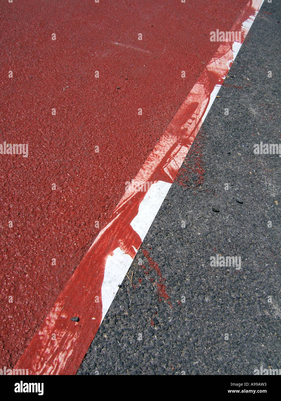 brown red paint on road - cycle path construction Stock Photo - Alamy