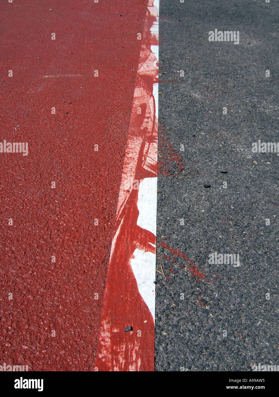 brown red paint on road - cycle path construction Stock Photo - Alamy