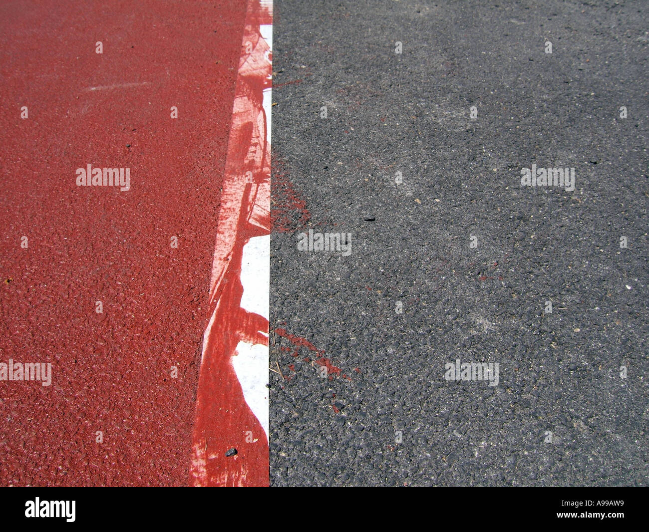 brown red paint on road - cycle path construction Stock Photo - Alamy