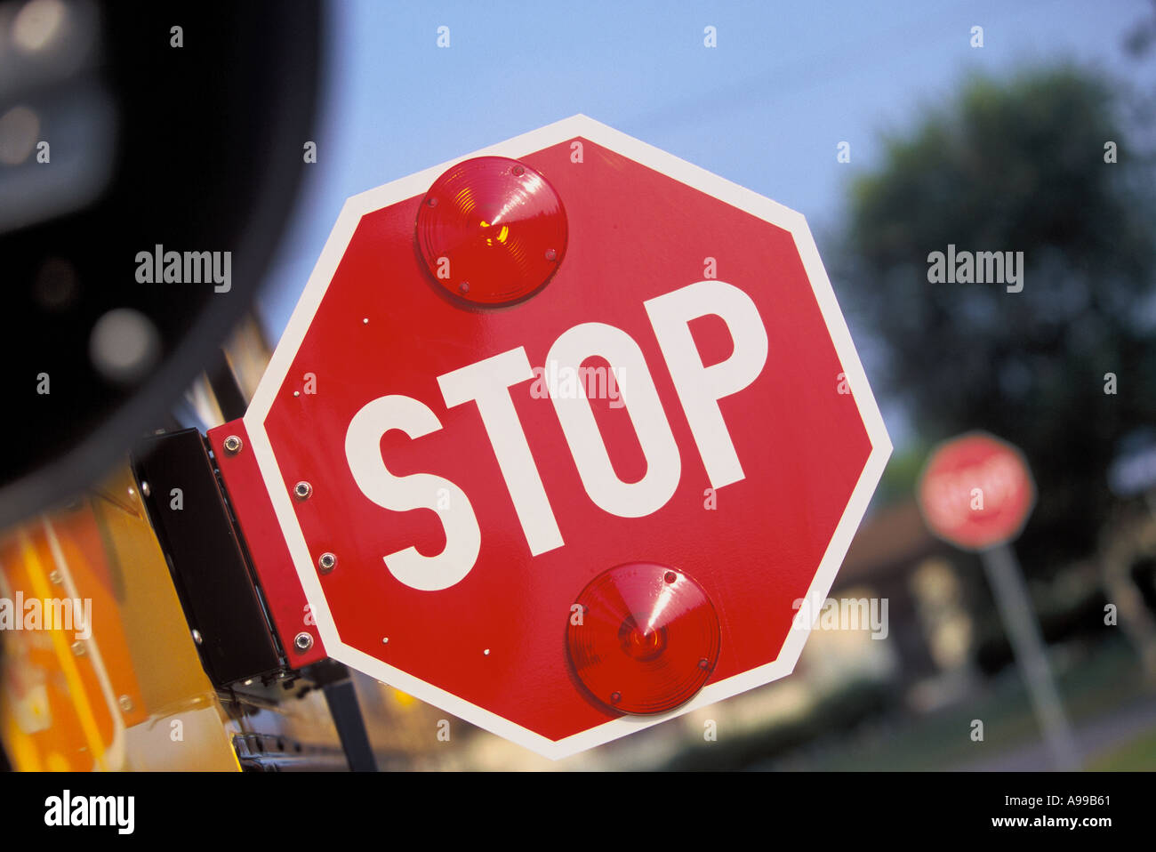 Close up of a stop sign that is extended from a school bus as it is ...