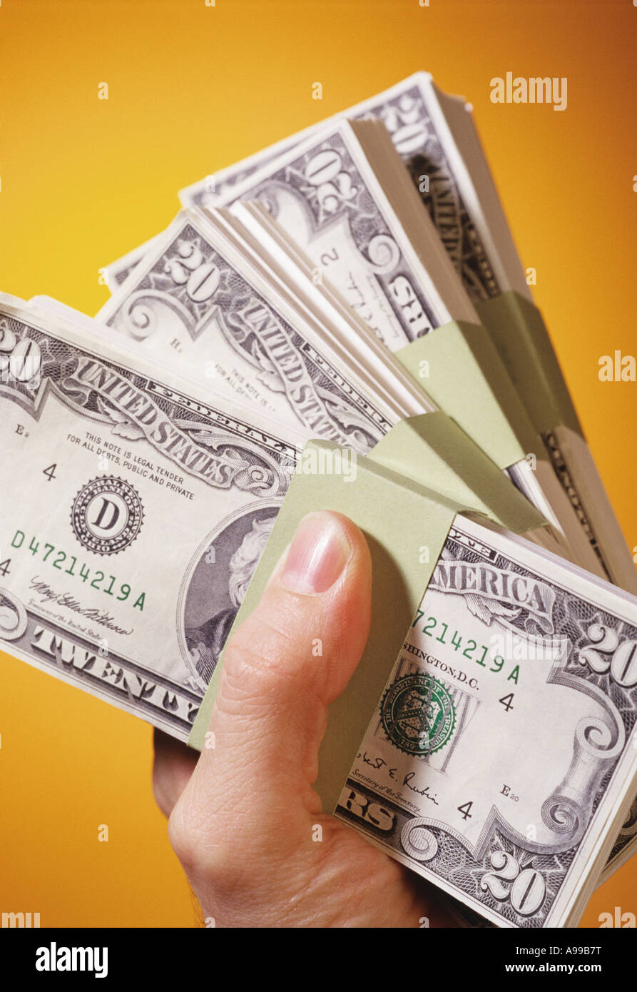 HAND HOLDING BUNDLES OF MONEY Stock Photo - Alamy