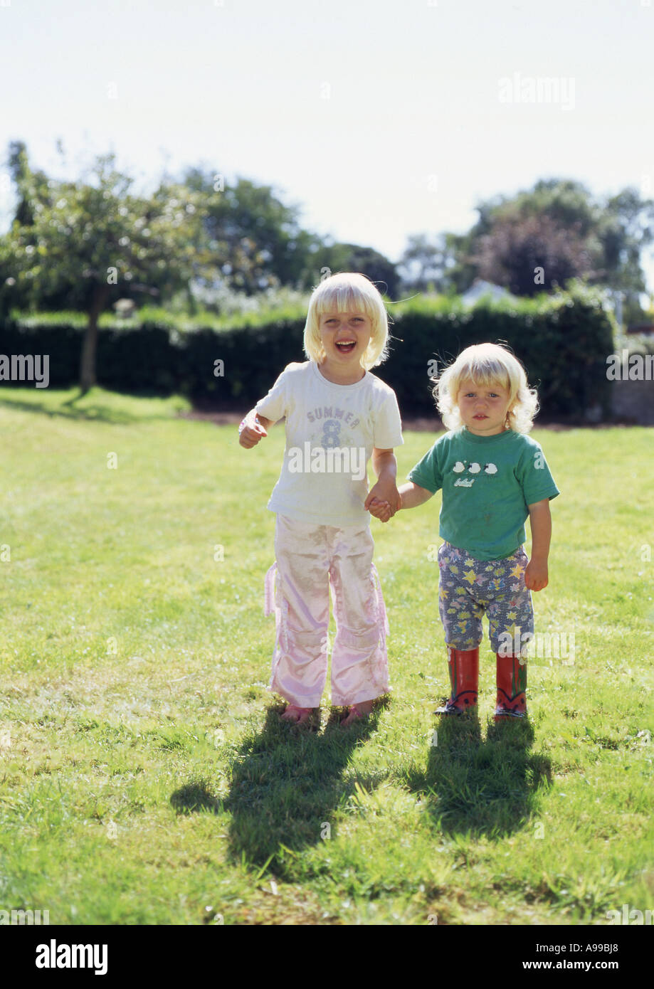 two sisters in garden Stock Photo - Alamy