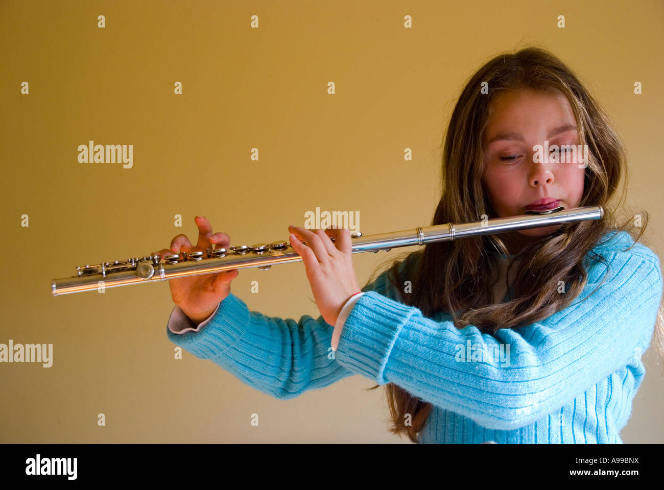 A young female music student playing the flute Stock Photo - Alamy