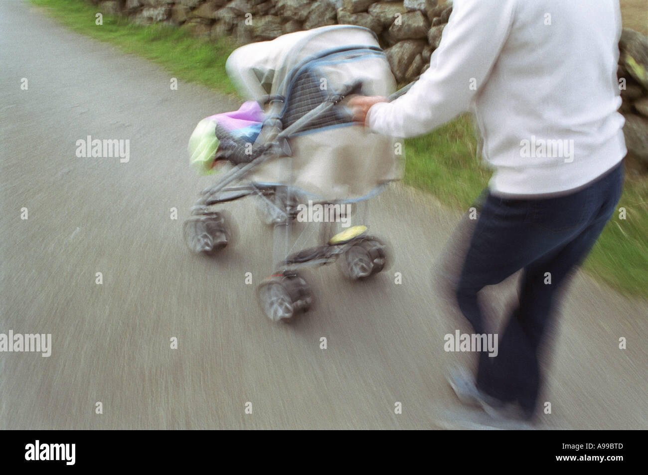 woman pushing pram Stock Photo - Alamy