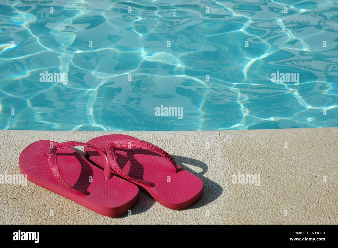 pink flip flops by swimming pool Stock Photo - Alamy