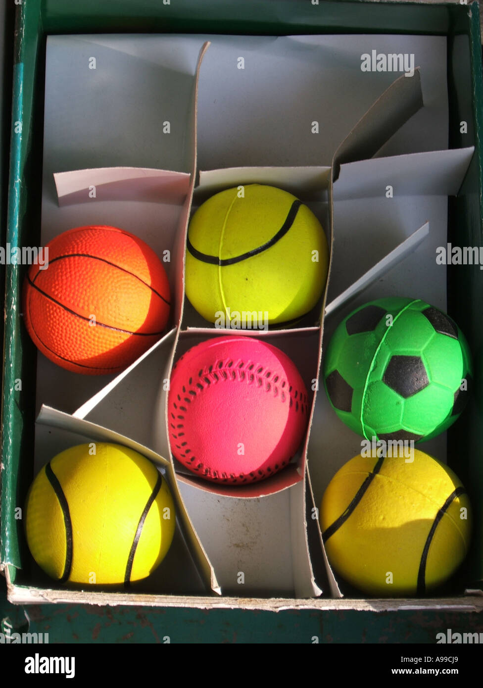 six pet sports balls in a box Stock Photo - Alamy