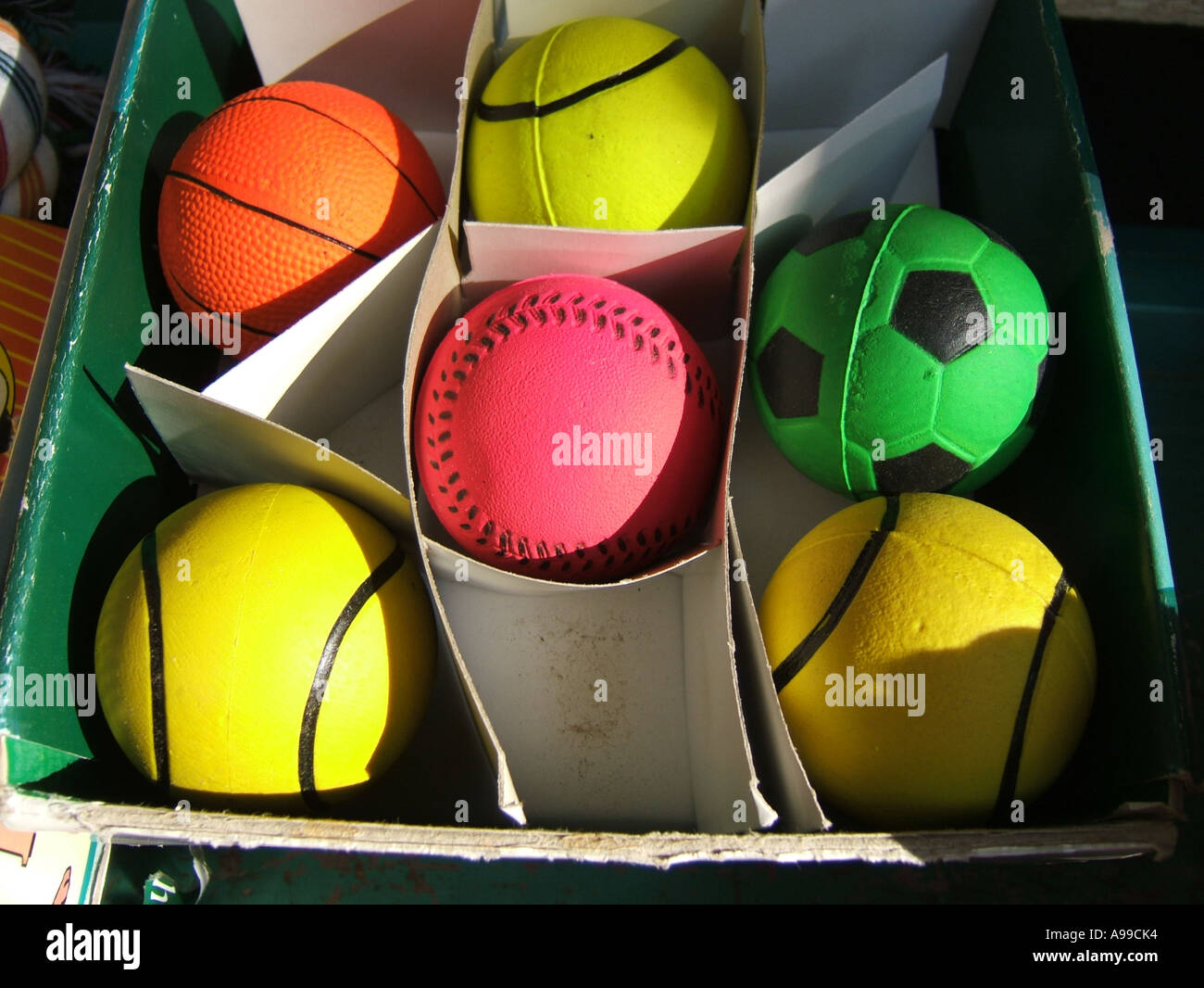 six pet sports balls in a box Stock Photo - Alamy