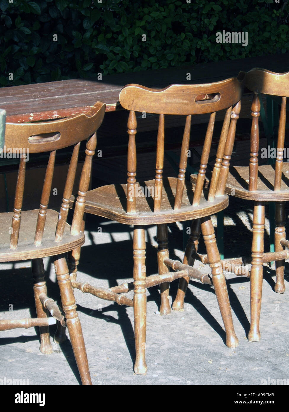 old fashioned wooden chairs by table Stock Photo - Alamy