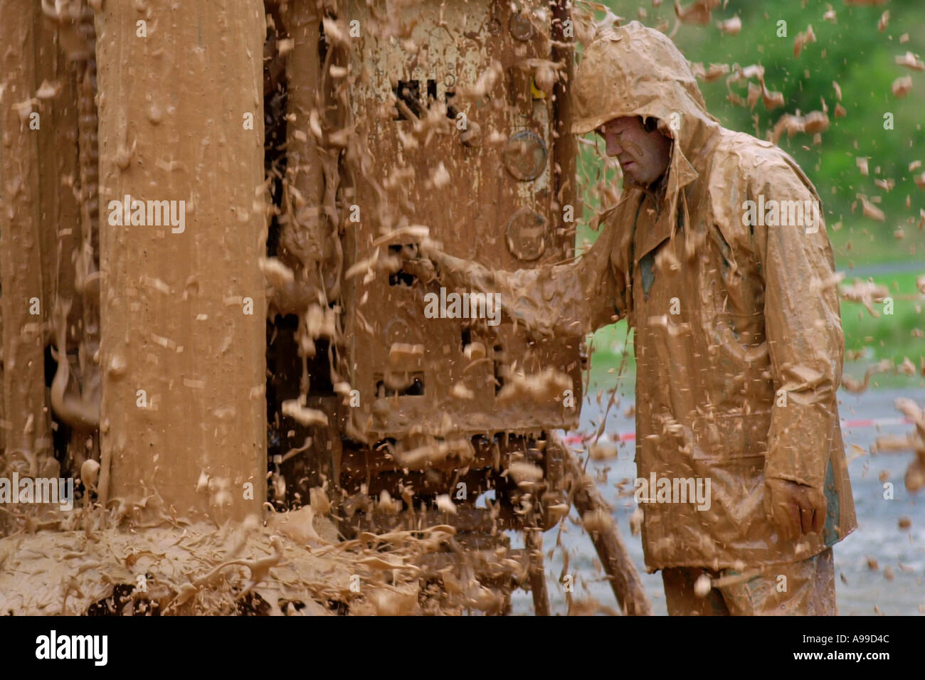 Engineer covered in foam and mud while drilling for water at the Gwalia ...
