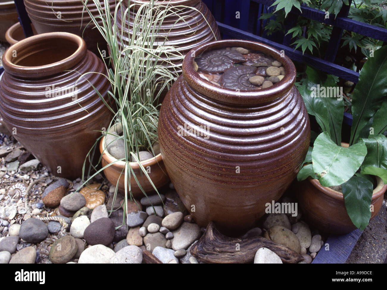 Large earthenware pots with grasses and large pebbles Chelsea Flower ...