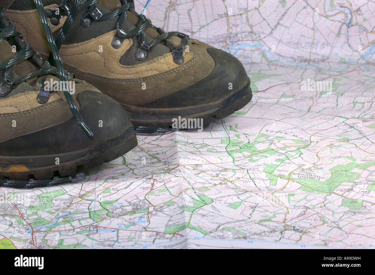 Pair of Hiking boots on a map background Stock Photo - Alamy