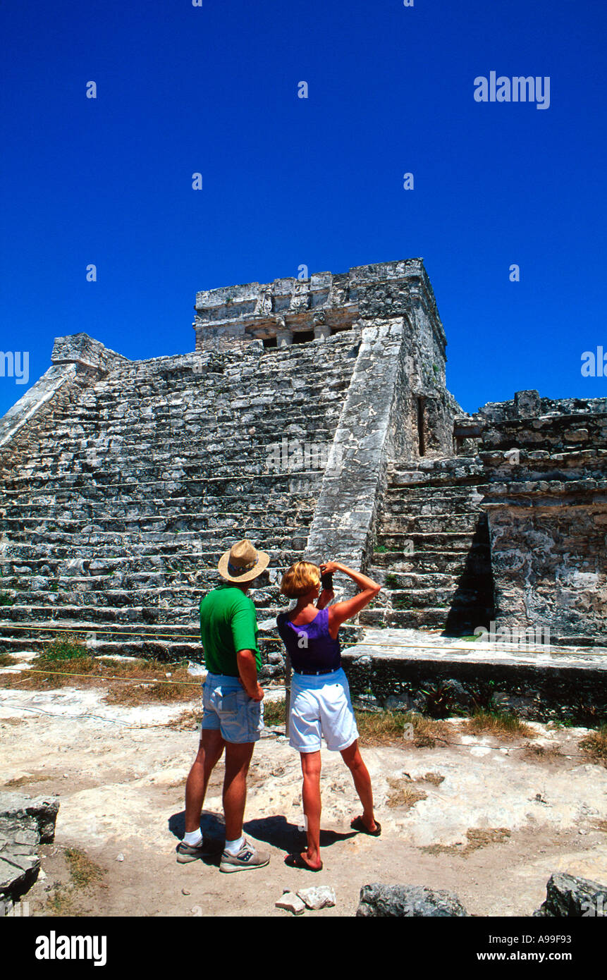 Colorful tourist couple at Mayan ruins in Tulum Mexico Stock Photo - Alamy