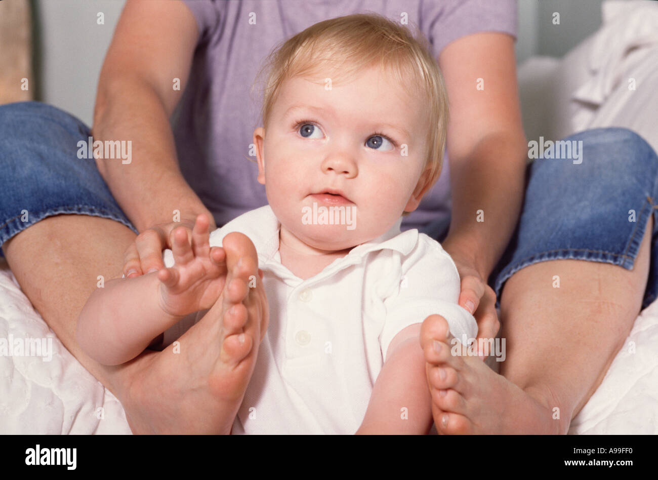 baby boy cuddling with mother Stock Photo - Alamy