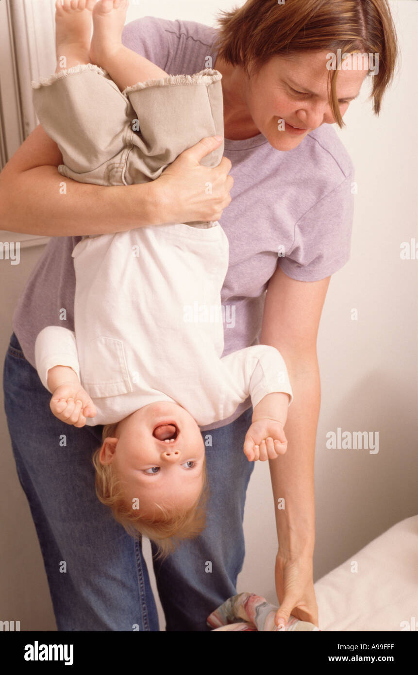 Baby held upside down hi-res stock photography and images - Alamy