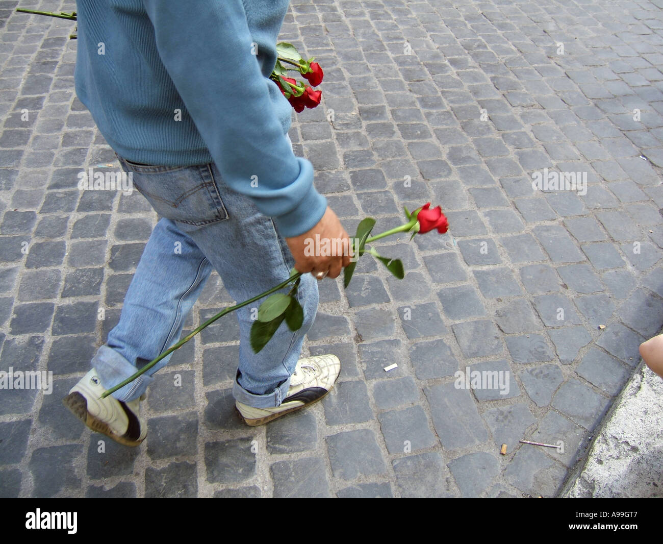 immigrant selling roses in rome Stock Photo - Alamy