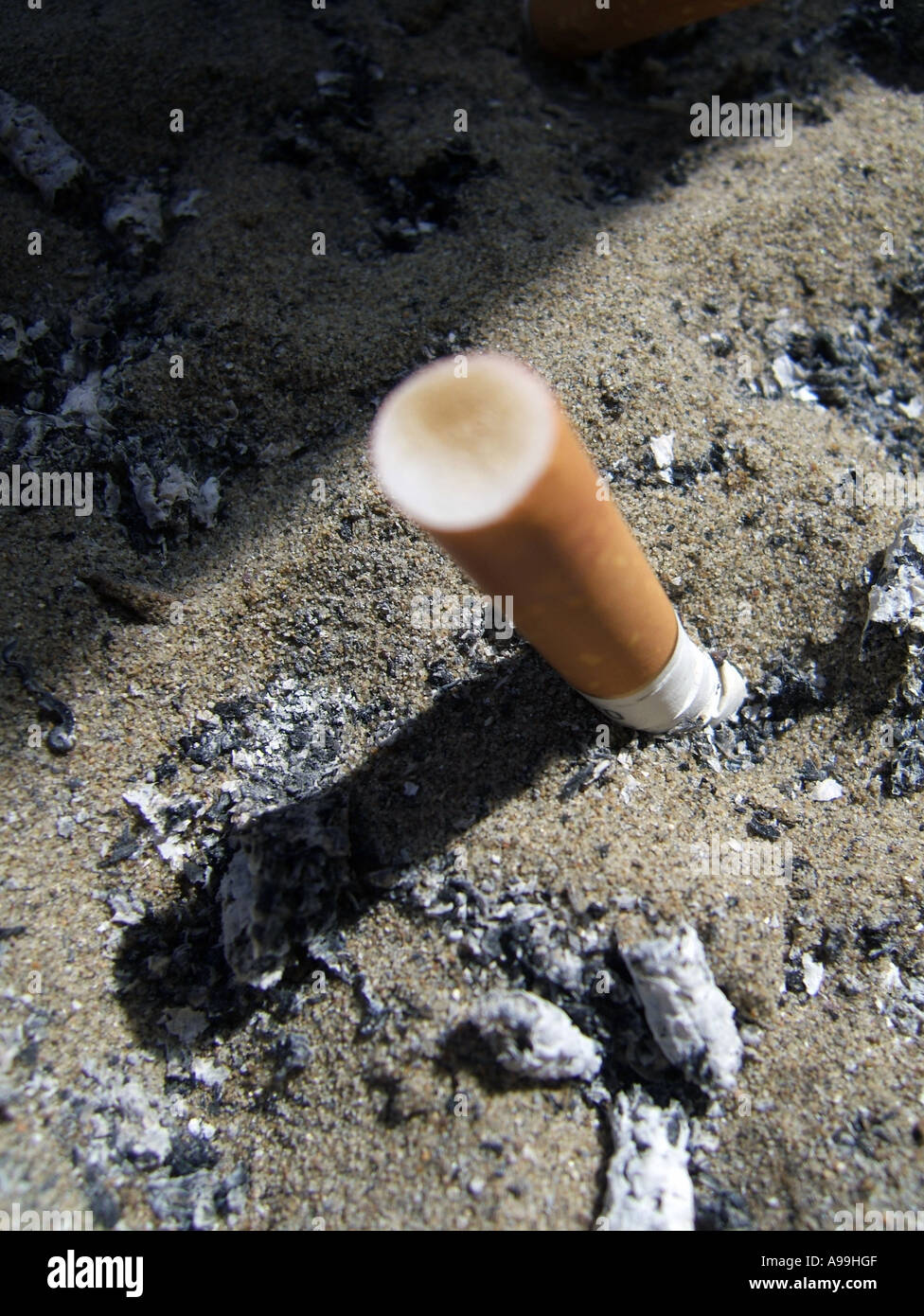 cigarette stubs in sand Stock Photo - Alamy
