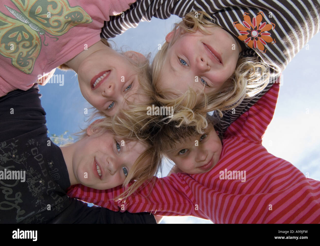 Four young girls 7 and 8 years old worm s eye view Stock Photo - Alamy