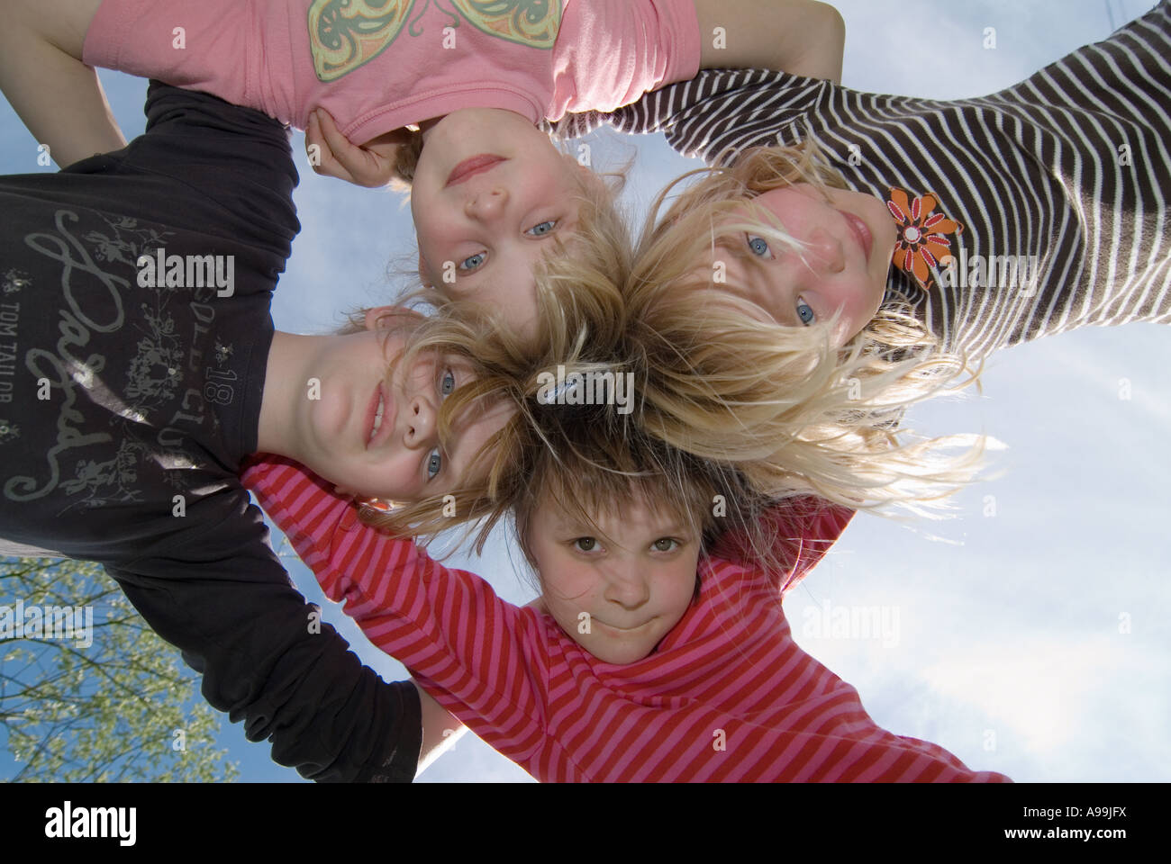 Four young girls 7 and 8 years old worm s eye view Stock Photo - Alamy