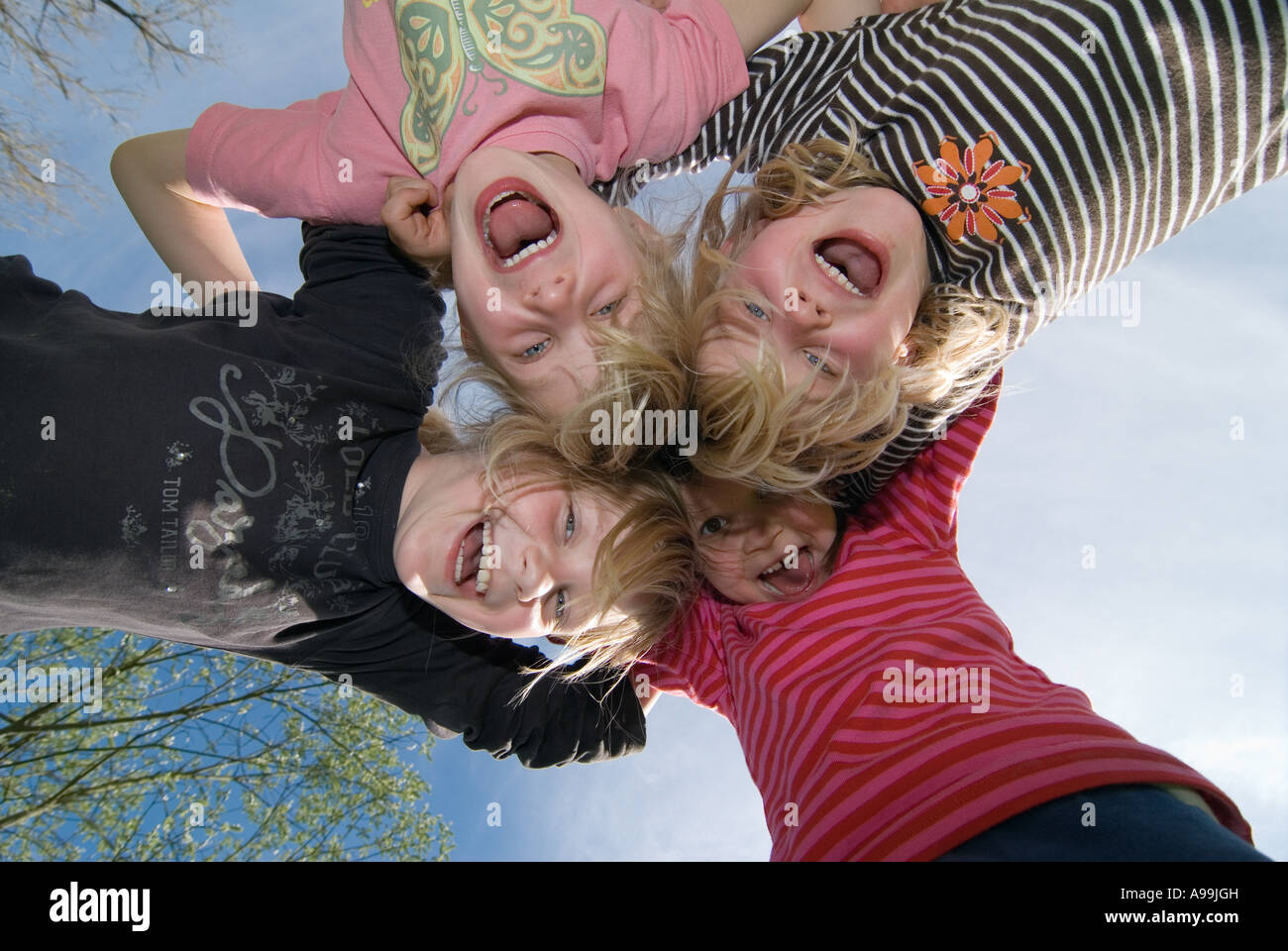 Four young girls 7 and 8 years old worm s eye view Stock Photo - Alamy