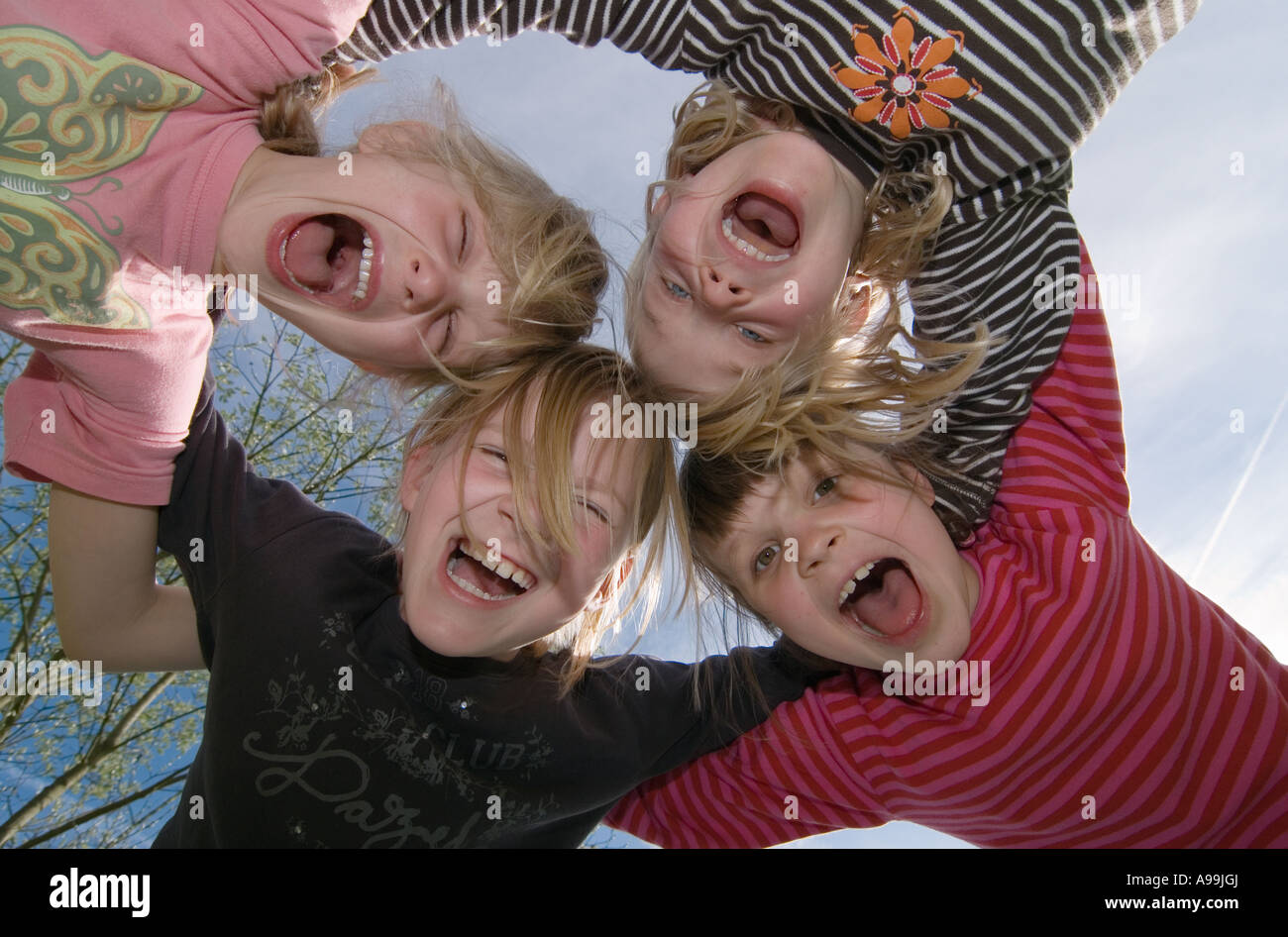Four young girls 7 and 8 years old worm s eye view Stock Photo - Alamy
