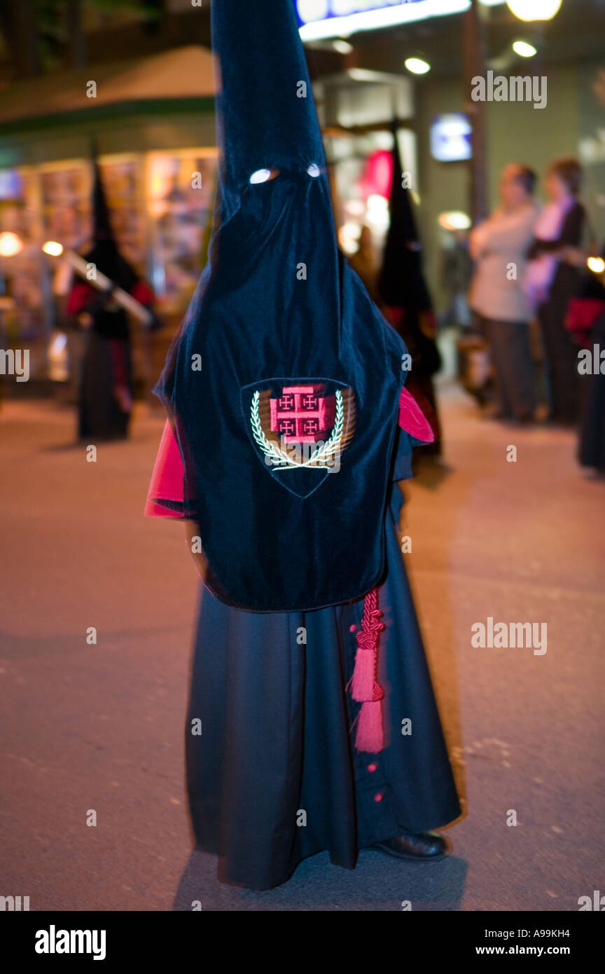Small child wearing black peaked hood during Holy Week procession ...