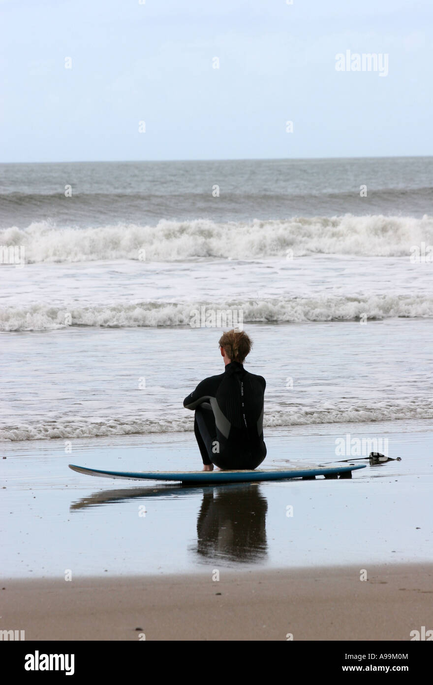 surfer sitting on their board watching the waves Stock Photo - Alamy