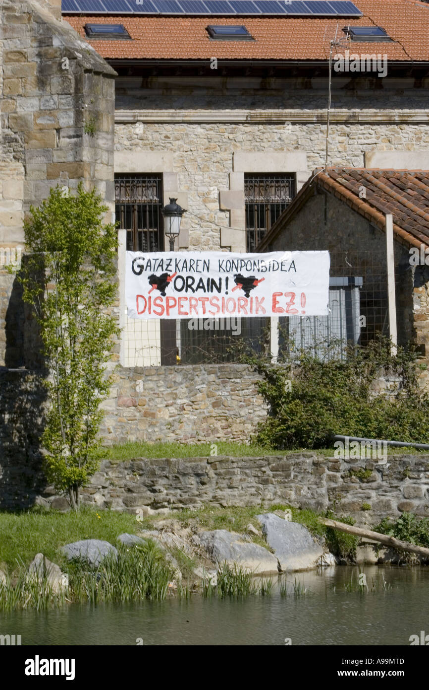Basque nationalist slogans in Euskara on wall next to river Balmaseda ...