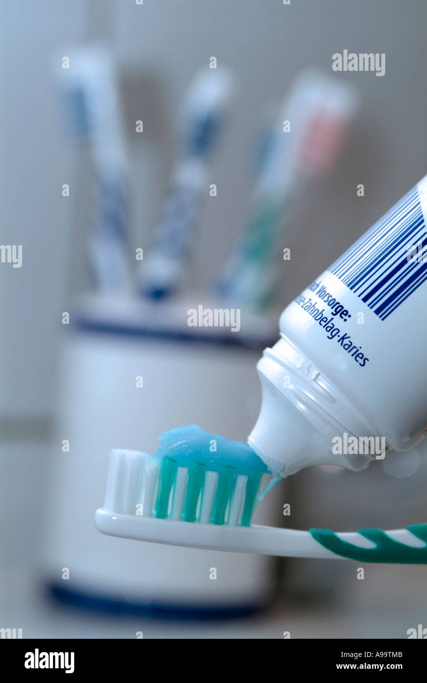 dental care pressing toothpaste on toothbrush in background four ...