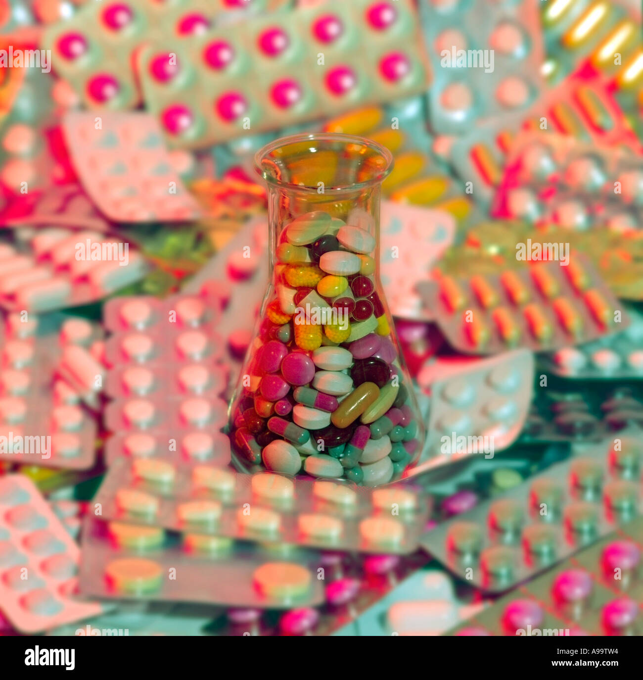 test tube vitro filled with pills and capsules on packages of pills ...