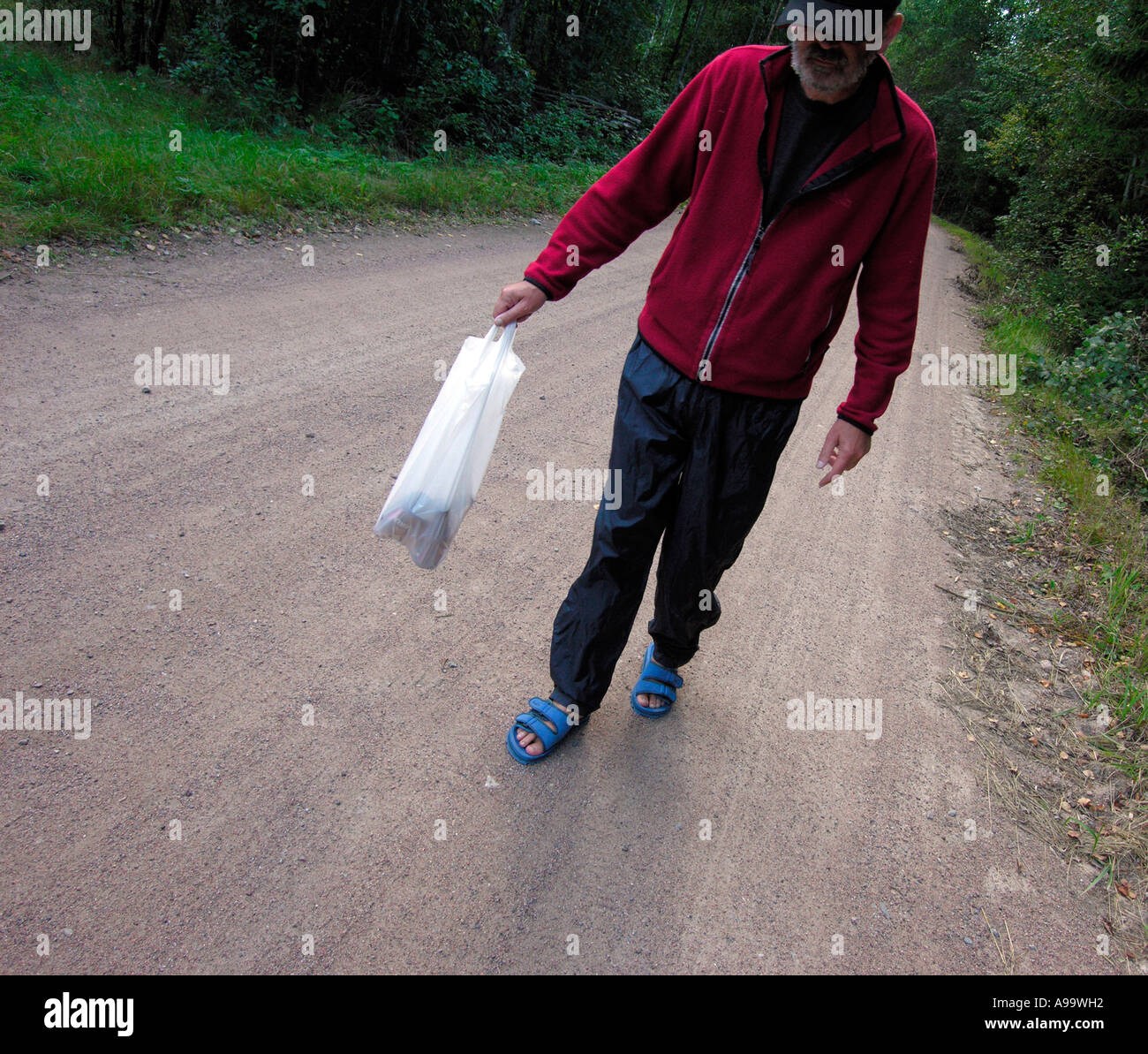 PR poor man down and out with bottles in a plastic bag in his hand ...