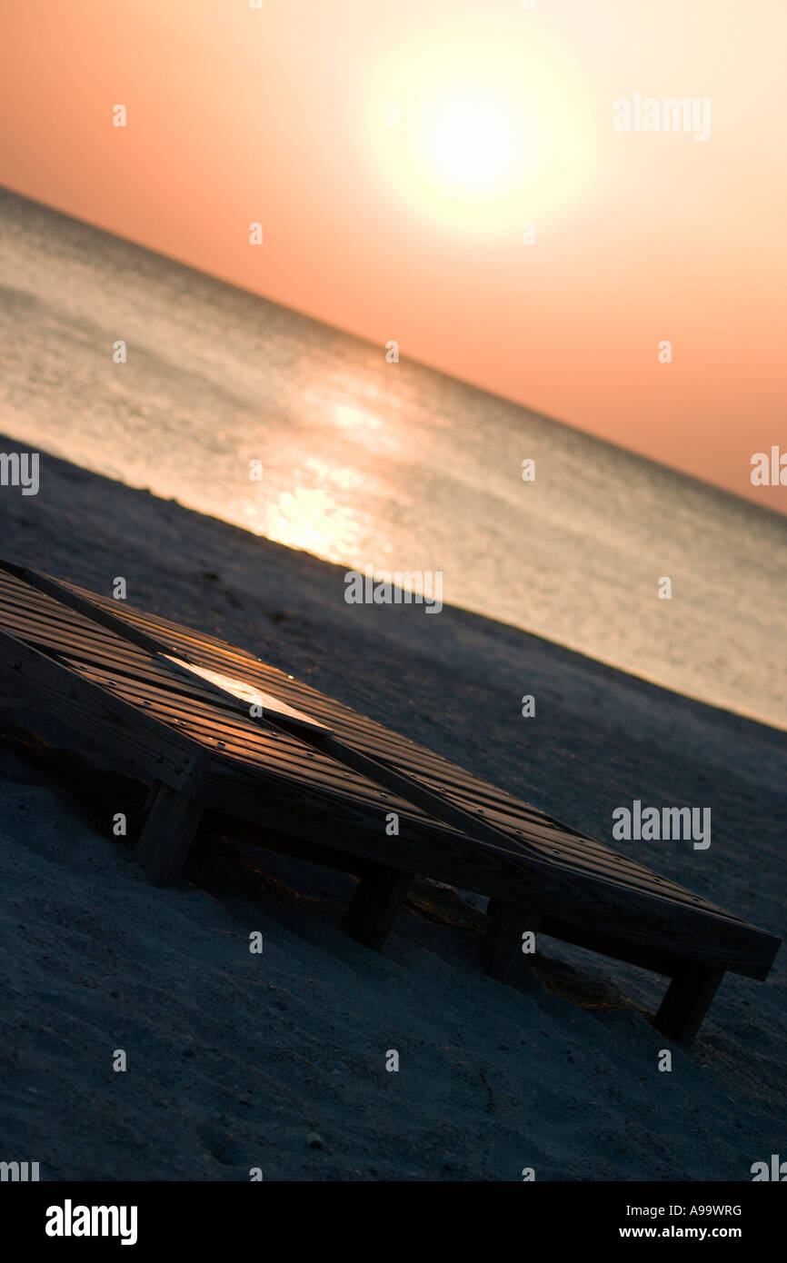 Beach chairs catch the sun's setting rays Stock Photo - Alamy