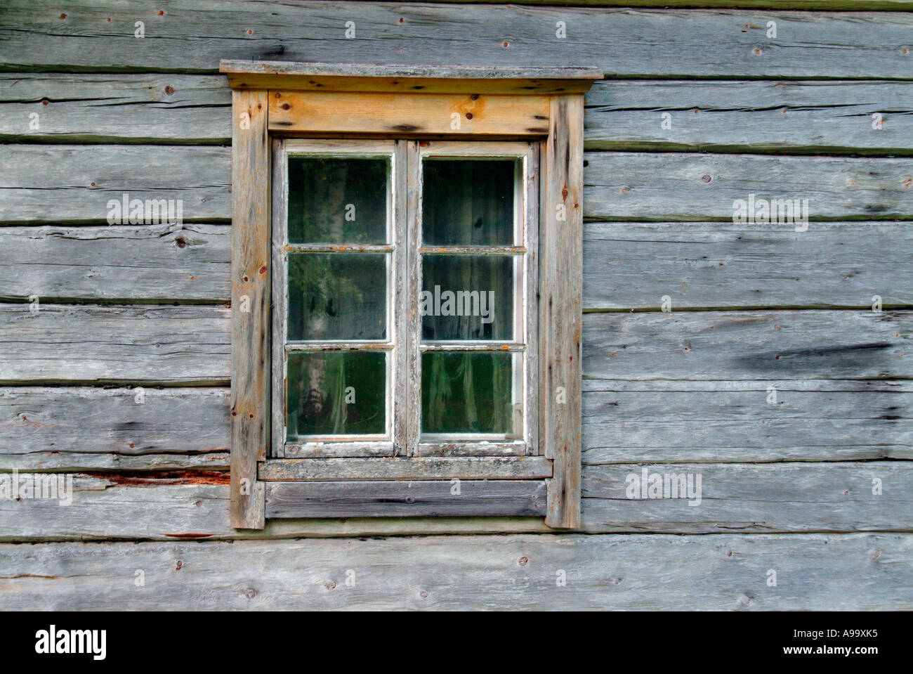 wall of an old grey timber blockhouse with a window in Finland Stock ...