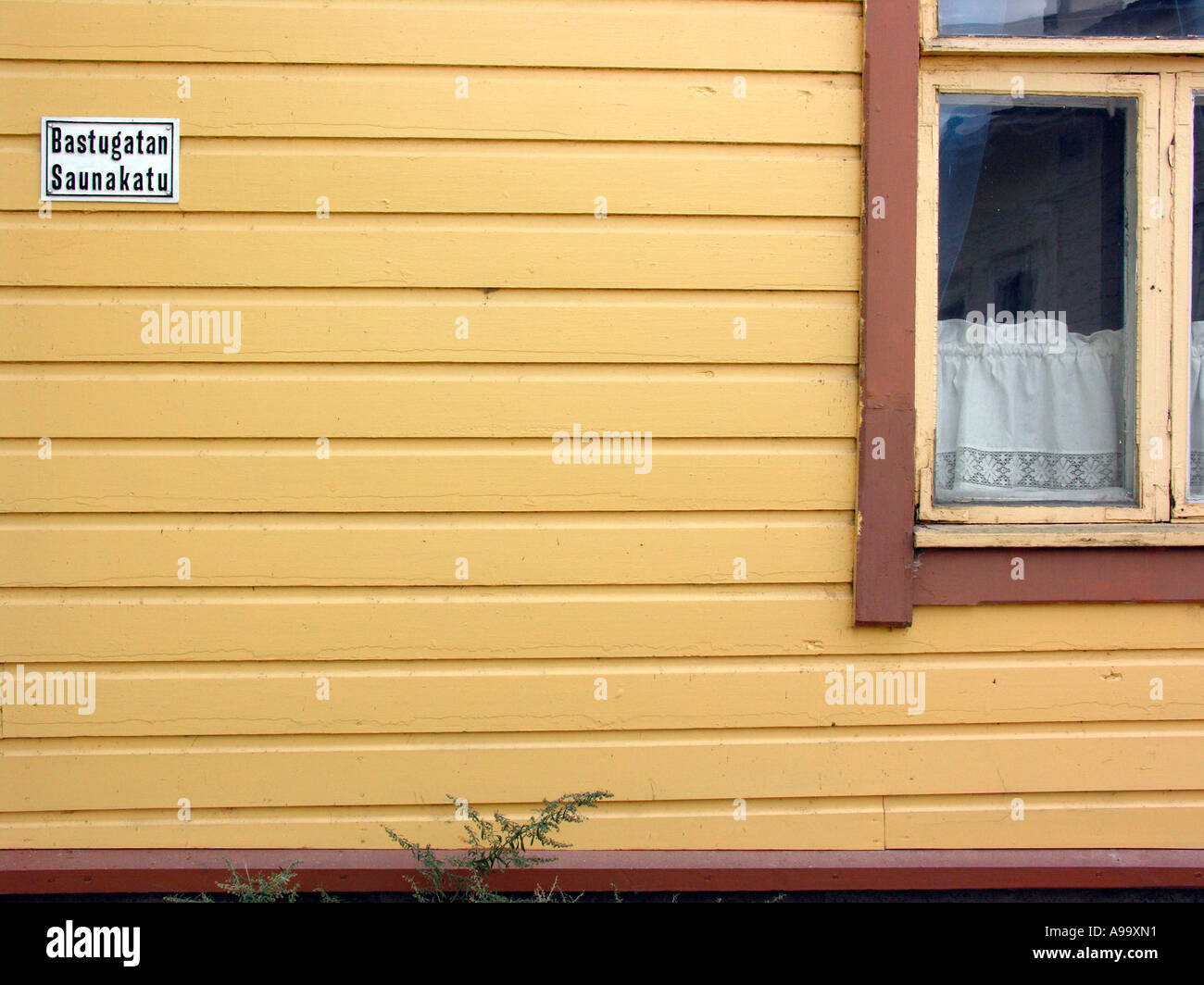 sauna street road sign on wall of a yellow timber house in the old town ...