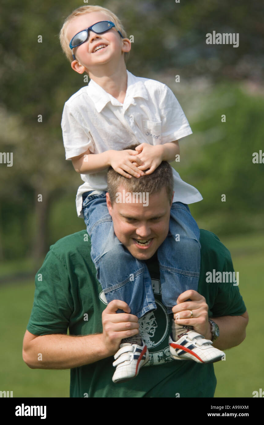 Child carried on shoulders hi-res stock photography and images - Alamy